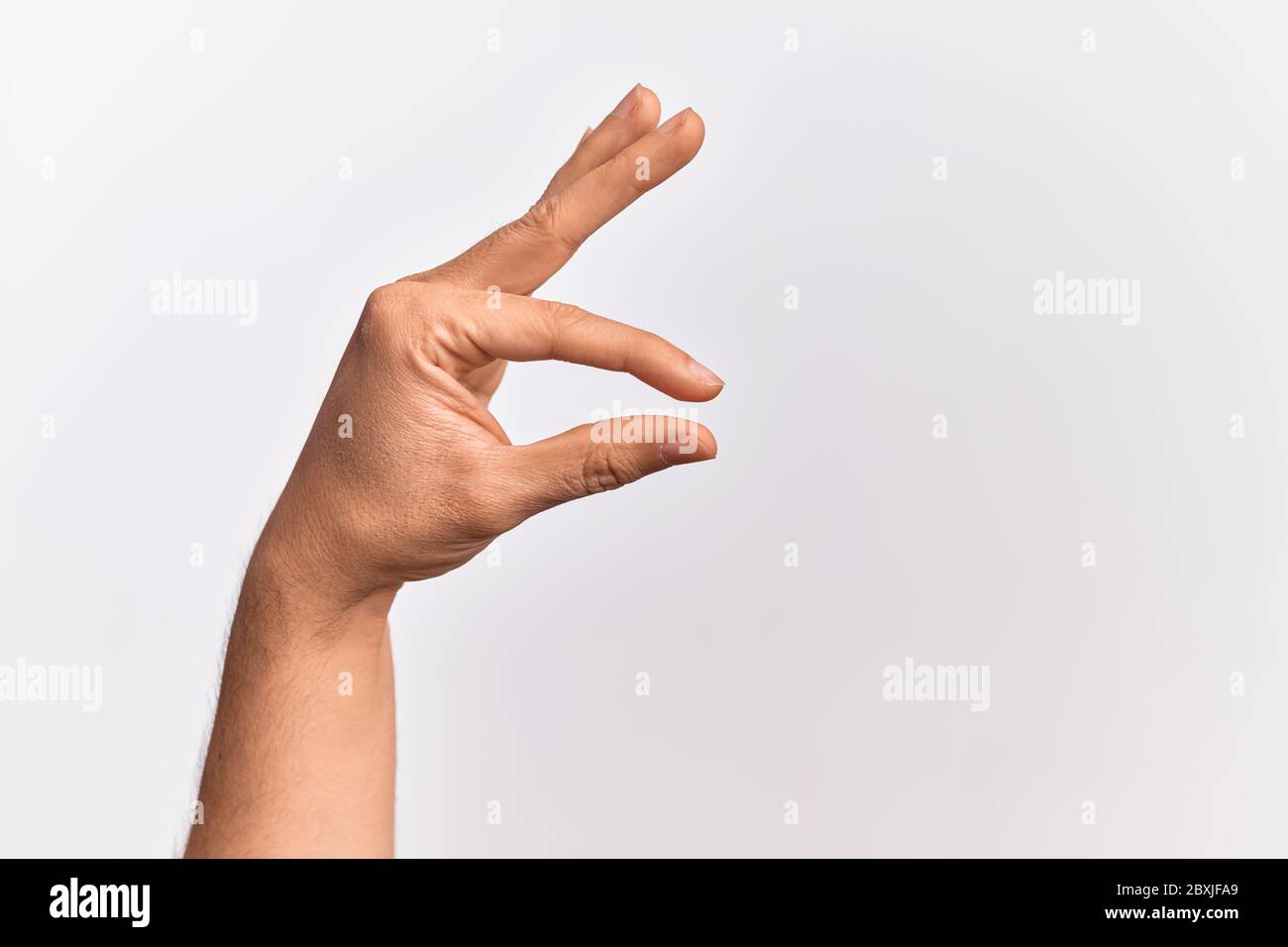 Hand of caucasian young man showing fingers over isolated white background picking and taking ...
