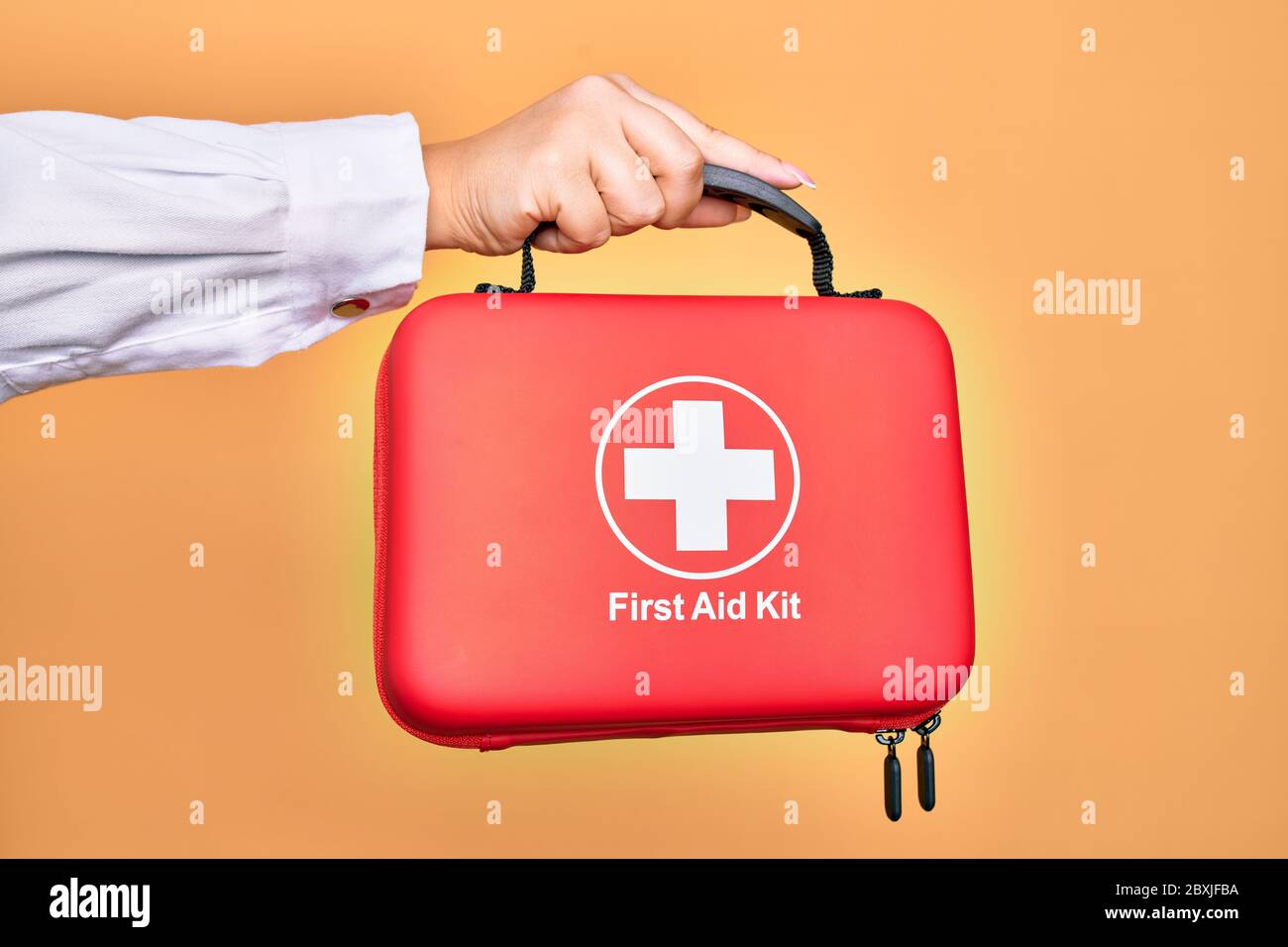 Hand of caucasian young woman holding first aid kit briefcase over ...