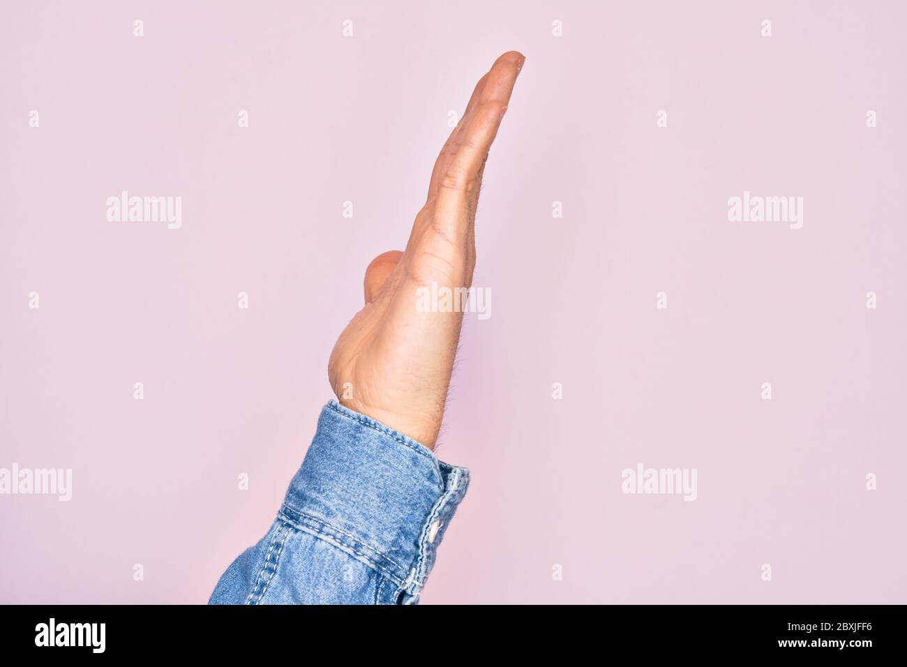 Hand of caucasian young man showing fingers over isolated pink ...