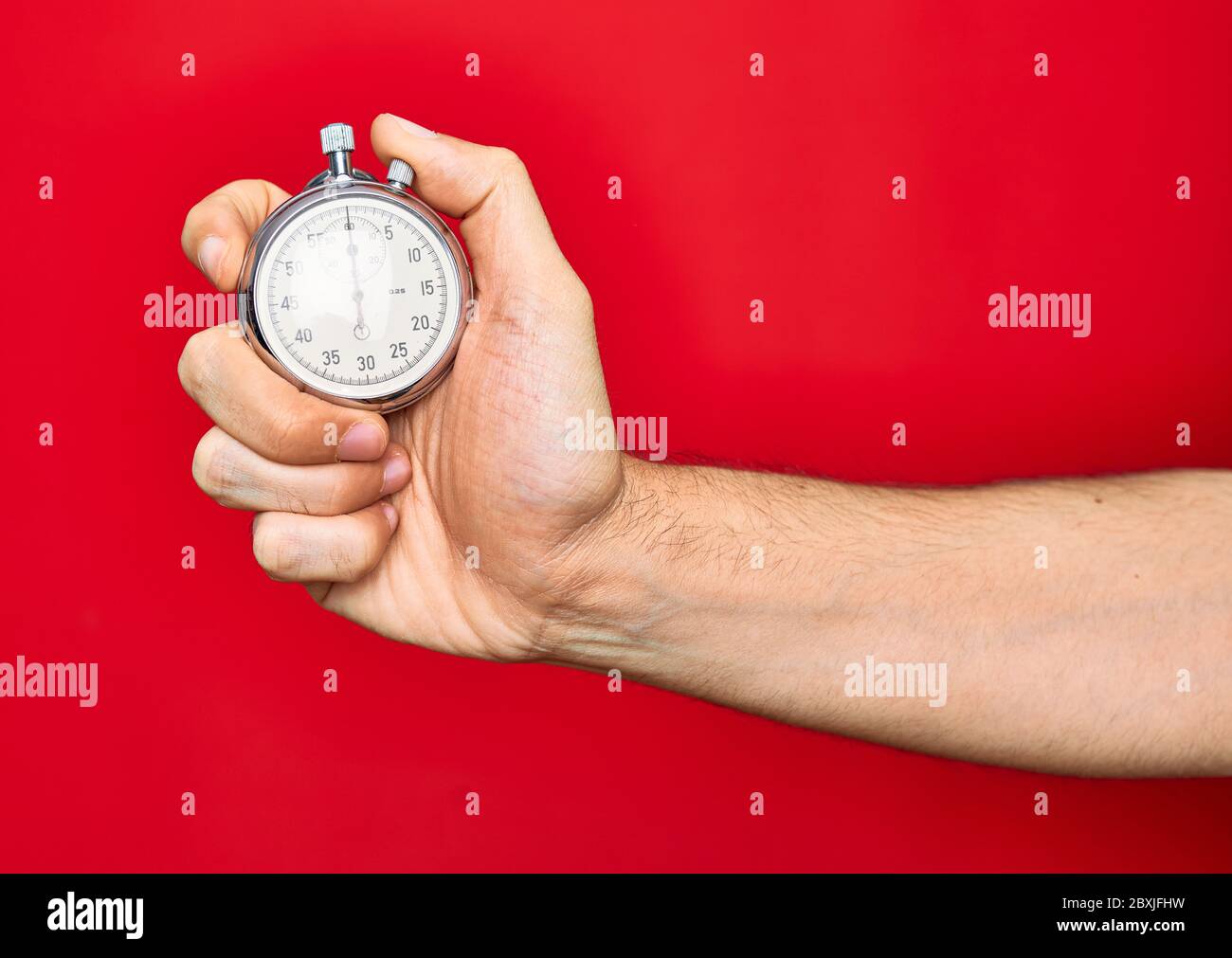 Beautiful hand of man holding stopwatch doing countdown over isolated ...