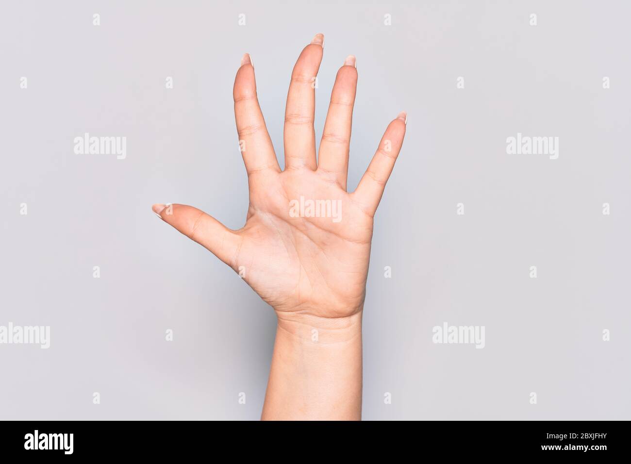 Hand of caucasian young woman counting number 5 showing five fingers ...
