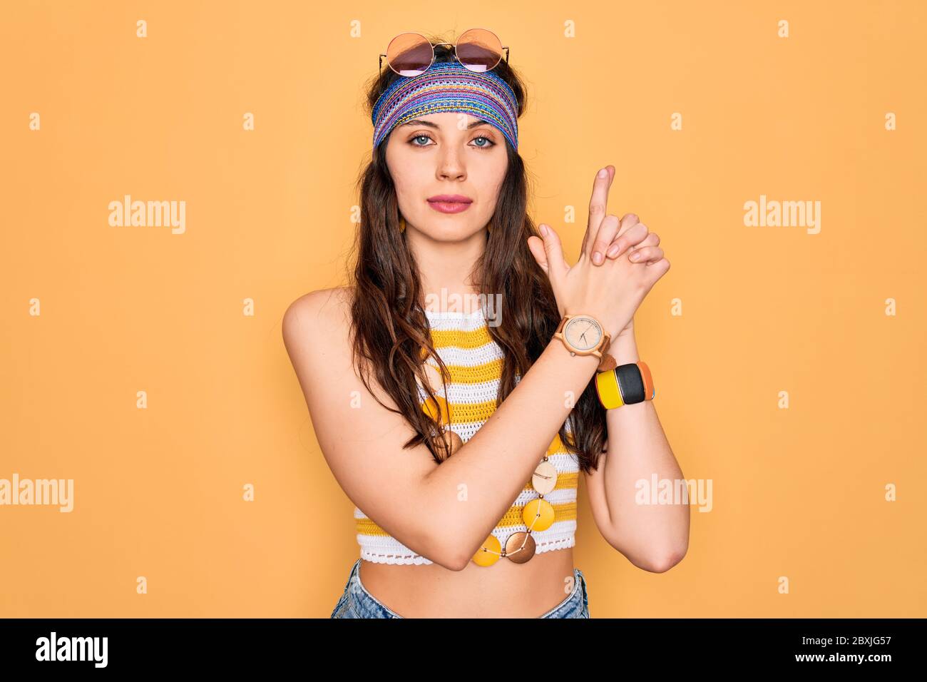 Young beautiful hippie woman with blue eyes wearing accesories and ...