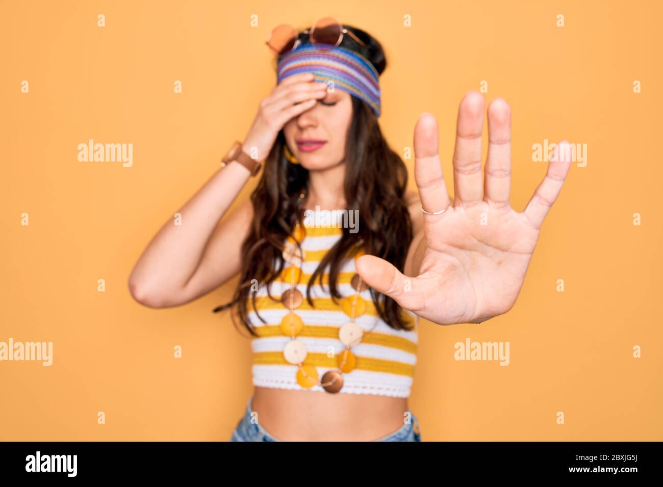 Young beautiful hippie woman with blue eyes wearing accesories and ...