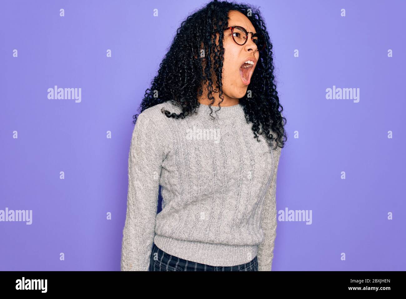 Young african american woman wearing casual sweater and glasses over ...