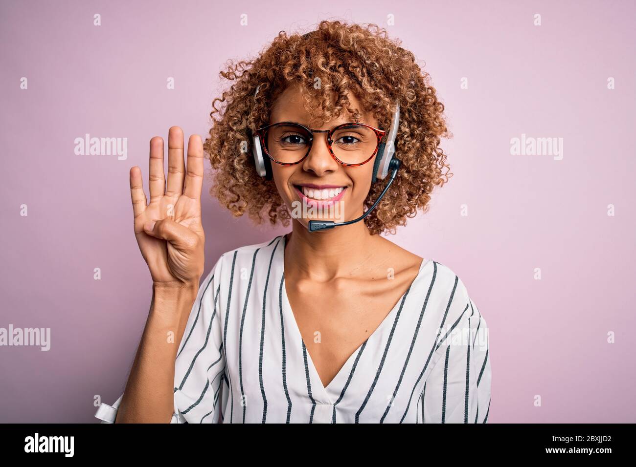 African american curly call center agent woman working using headset ...