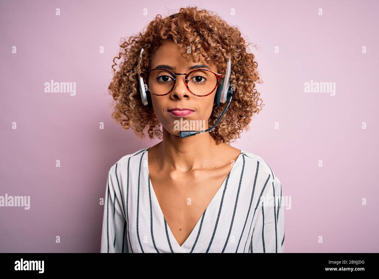 African american curly call center agent woman working using headset ...