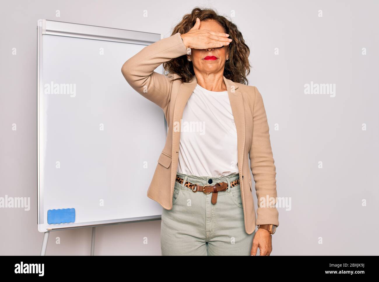 Middle age senior business woman standing on seminar presentation by ...