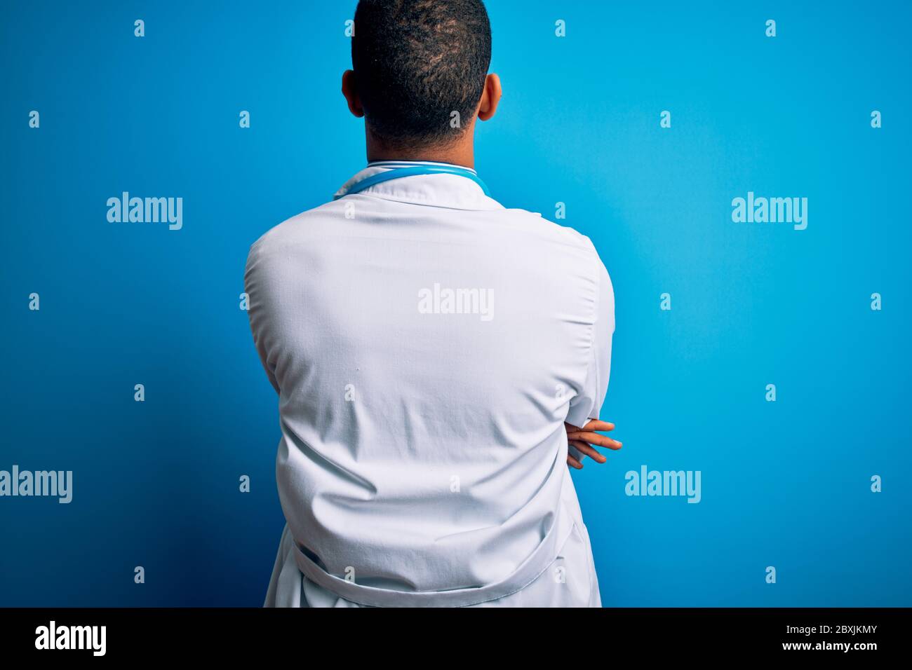 Handsome african american doctor man wearing coat and stethoscope over ...