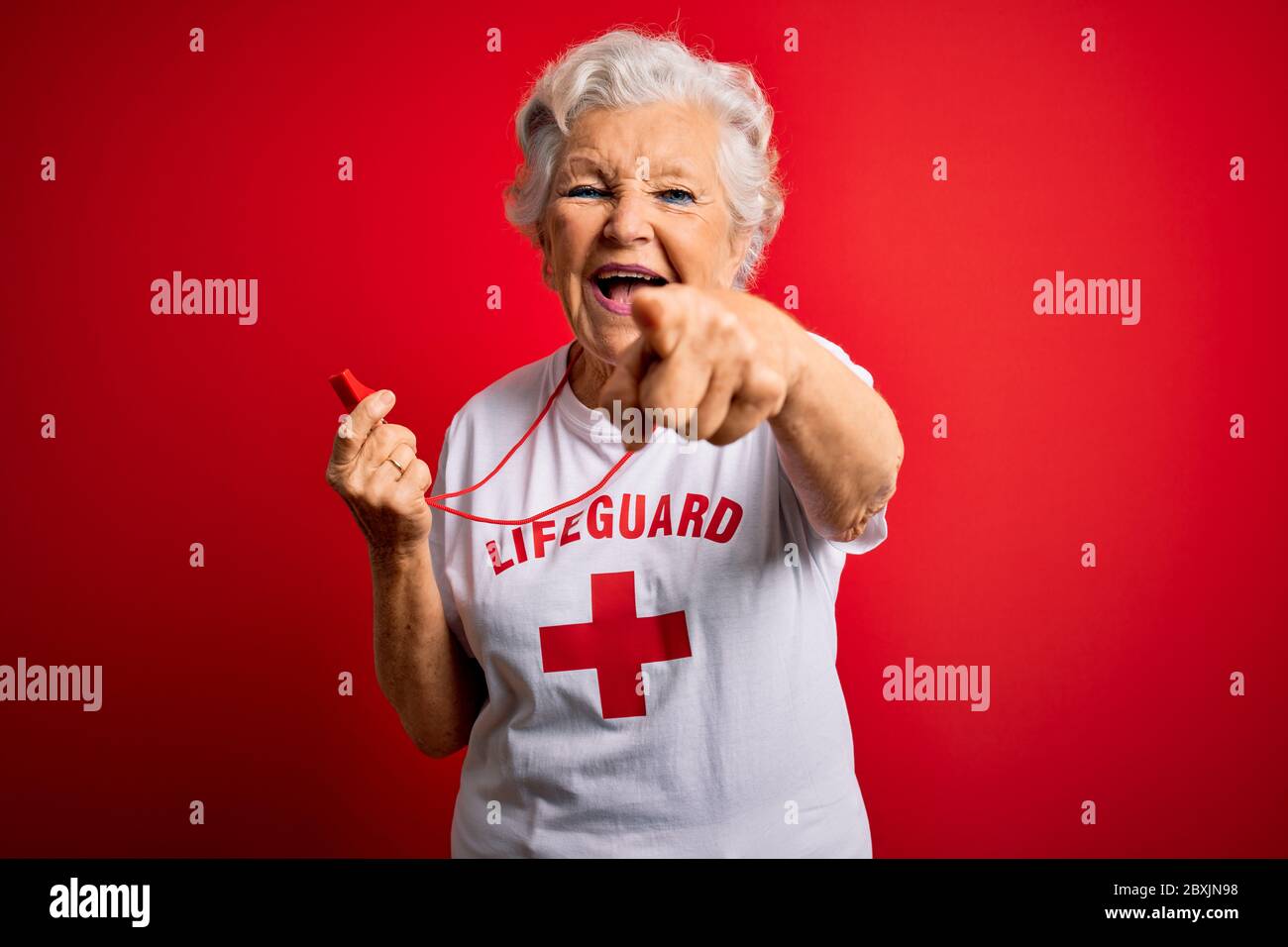 Senior beautiful grey-haired lifeguard woman wearing t-shirt with red ...