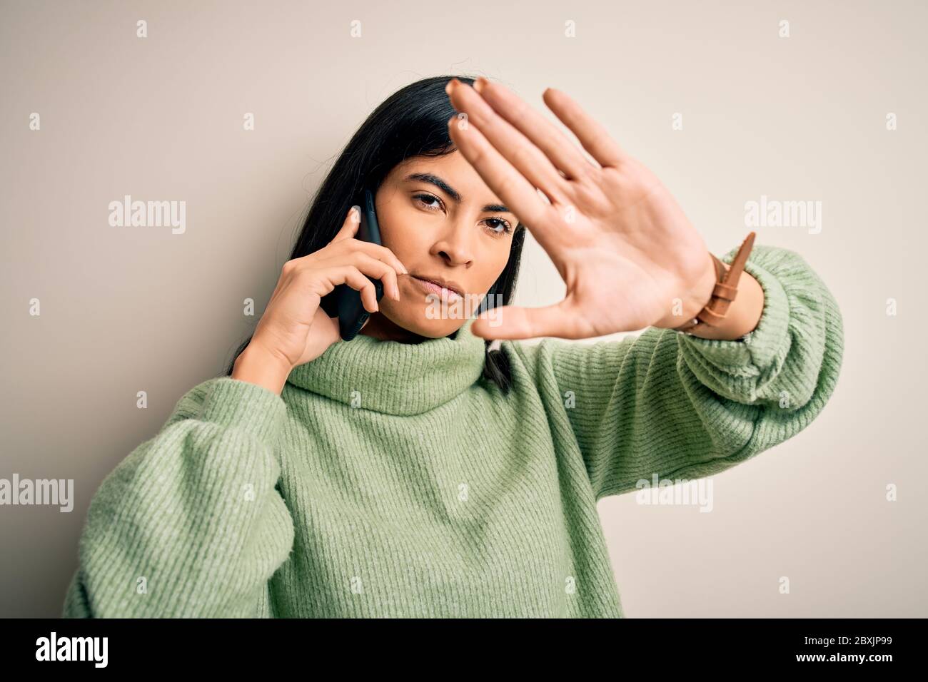 Young beautiful hispanic woman having a conversation talking on the ...