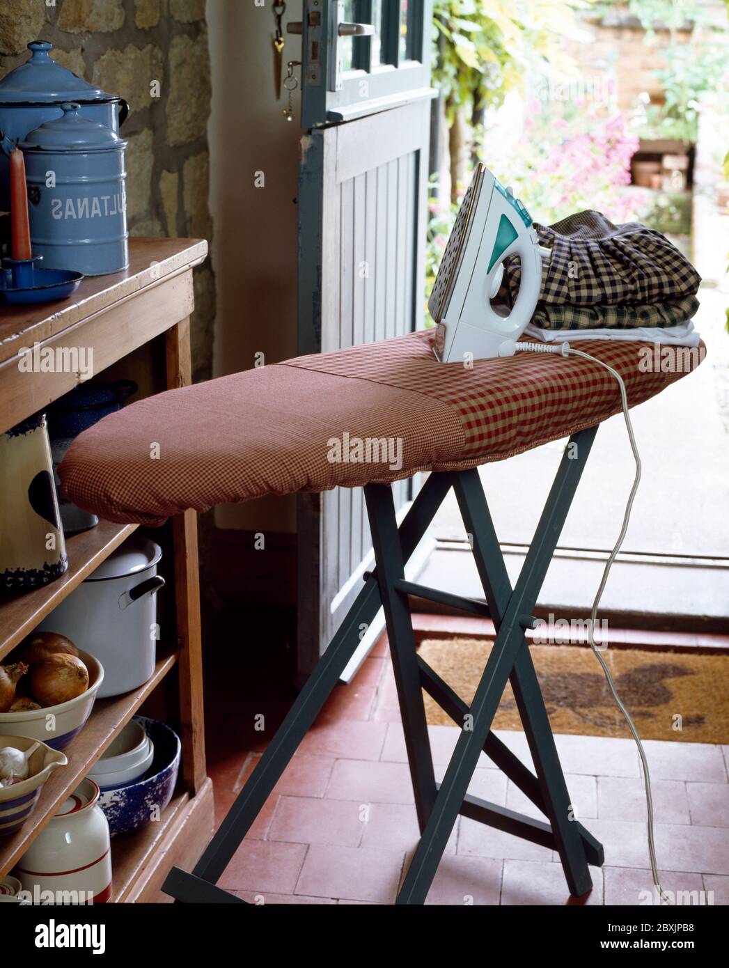 Iron on well-padded board cover Stock Photo - Alamy