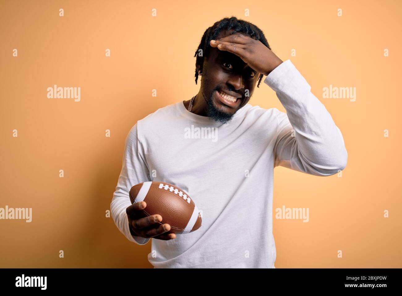 Young african player man playing rugby holding american football ball ...