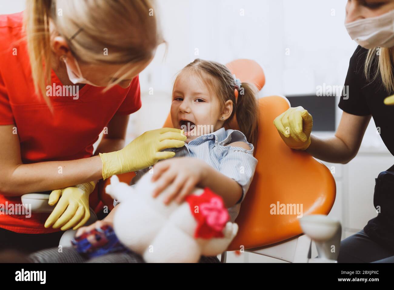 Happy little girl during dental check up Stock Photo - Alamy