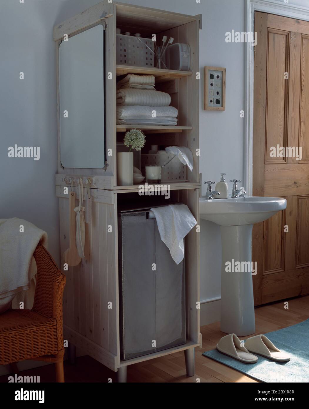 Detail of bathroom storage and dirty linen basket Stock Photo - Alamy