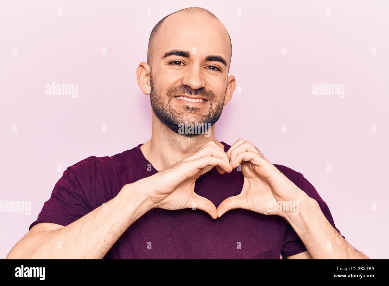 Young handsome bald man wearing casual t shirt smiling in love doing ...