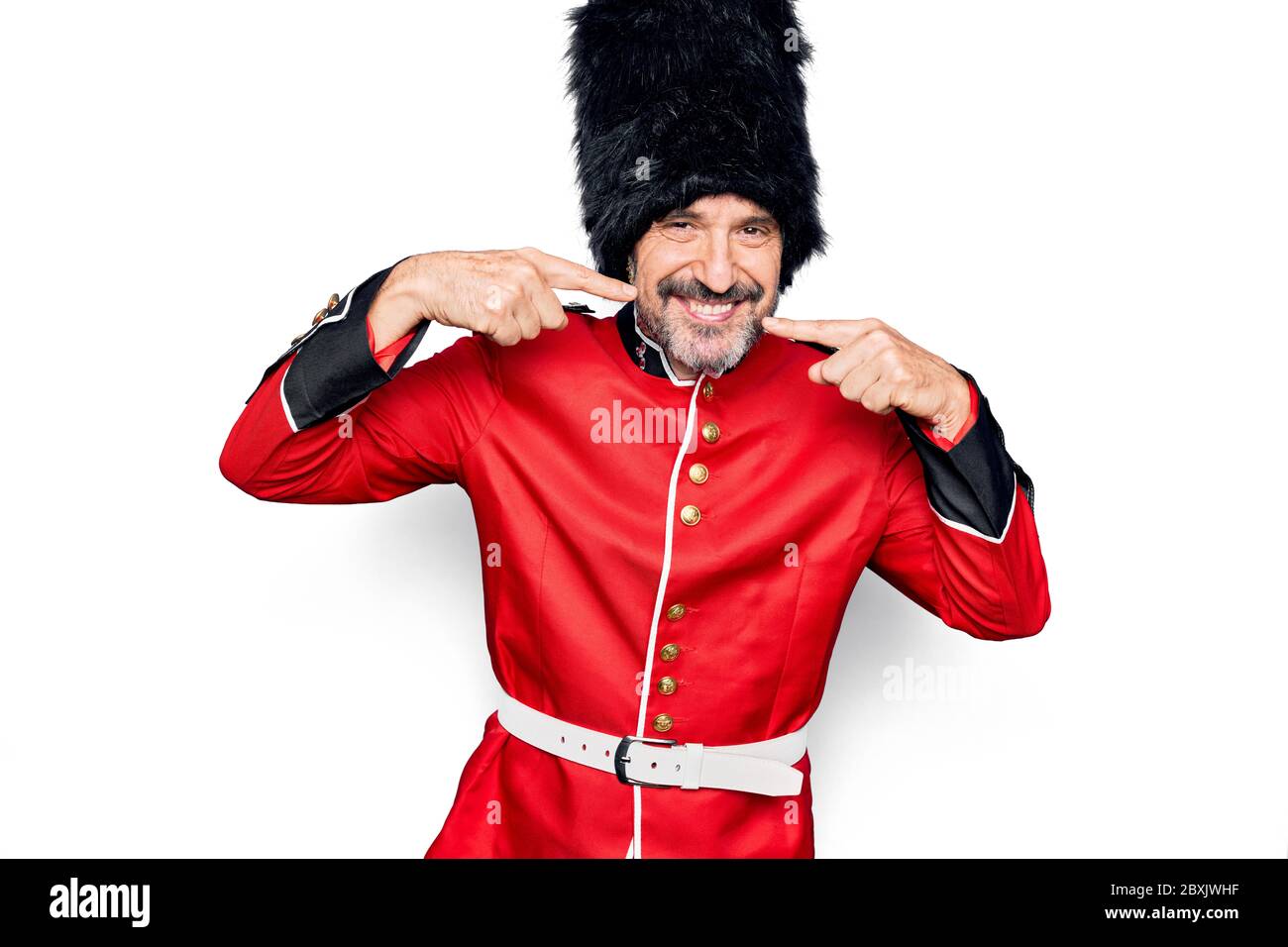 Middle age handsome wales guard man wearing traditional uniform over ...
