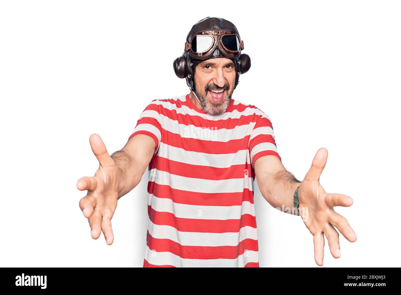 Middle age aviator man wearing vintage helmet and glasses over isolated ...