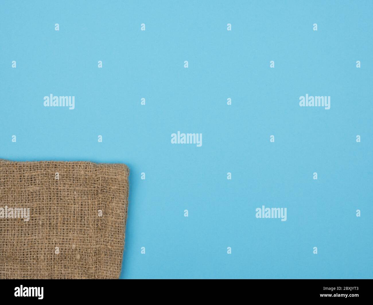 The texture of the burlap on a blue background Stock Photo - Alamy