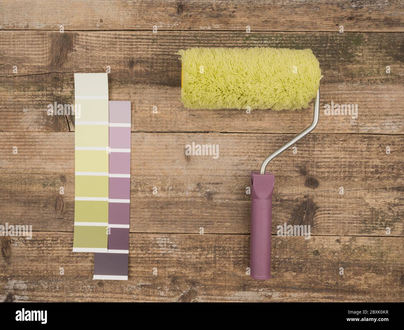 Paint roller and color palette on wooden background Stock Photo - Alamy