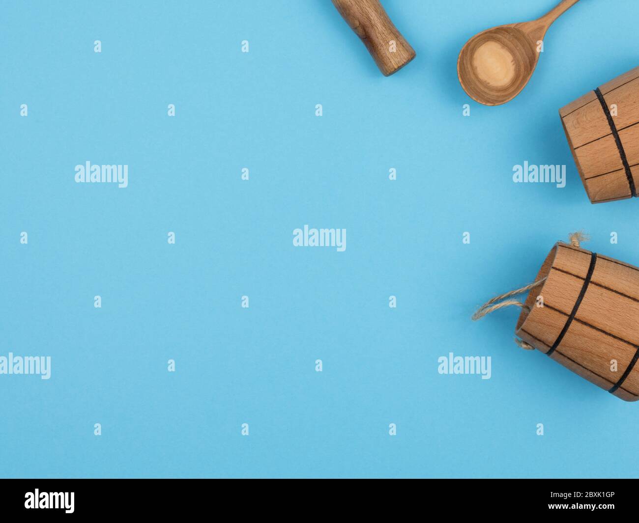 Wooden household items on a blue background Stock Photo - Alamy