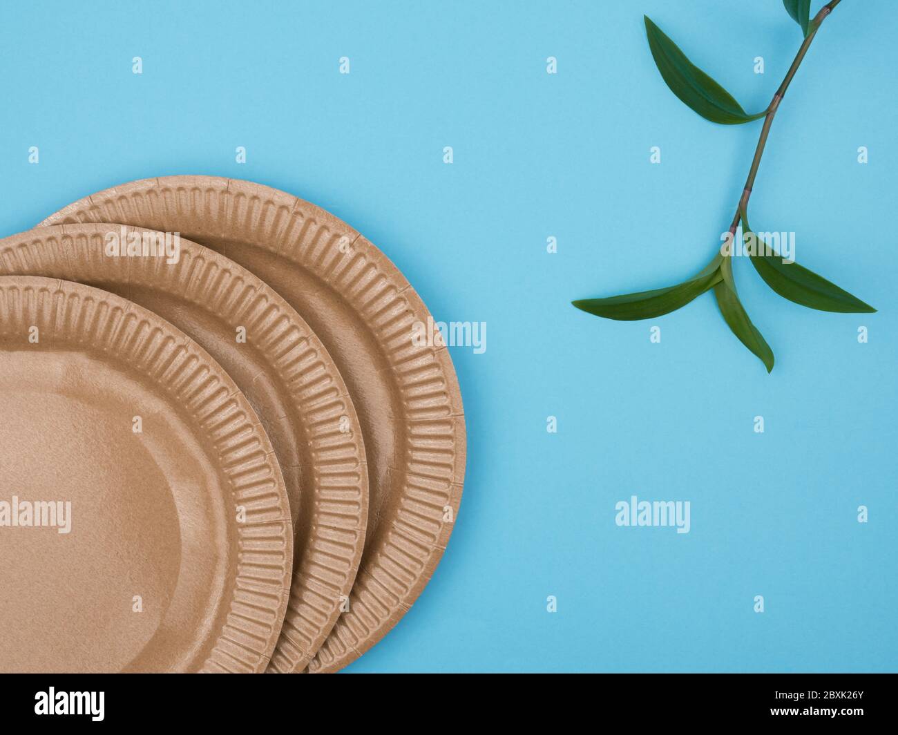Paper dishes against a blue background Stock Photo - Alamy