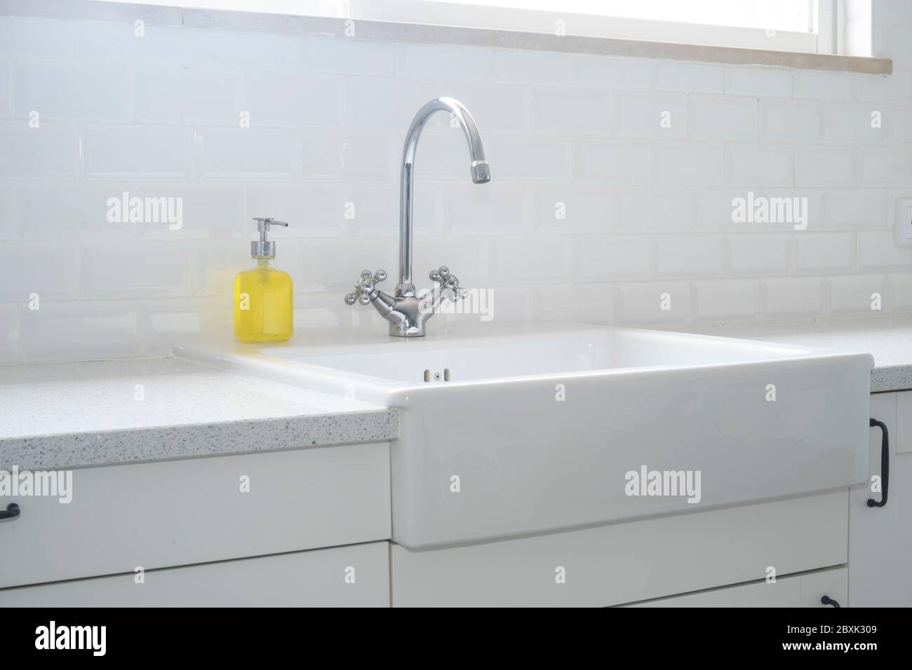 Contemporany kitchen style faucet and ceramic sink Stock Photo - Alamy