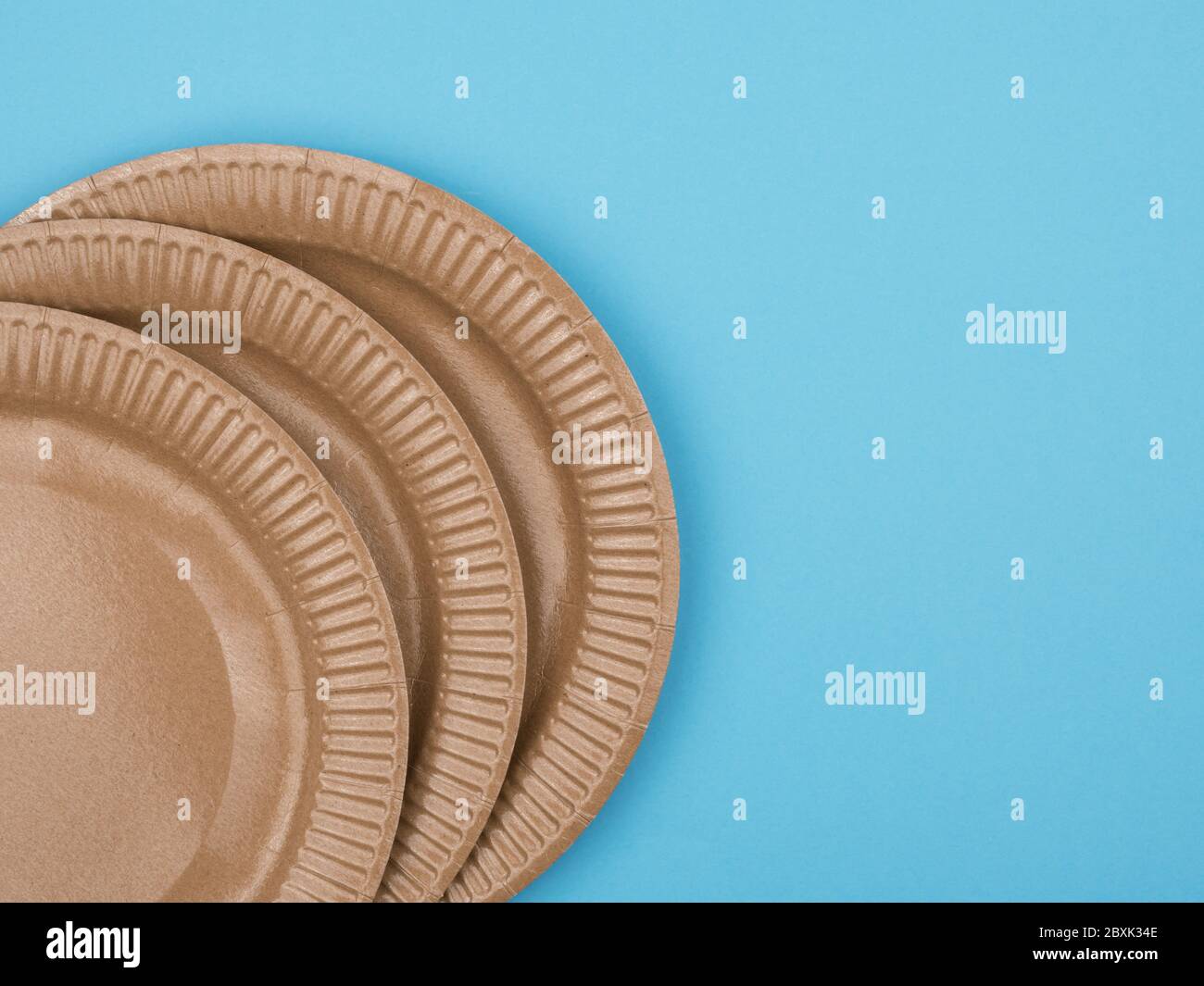 Cardboard plates on a blue background. The view from the top ...