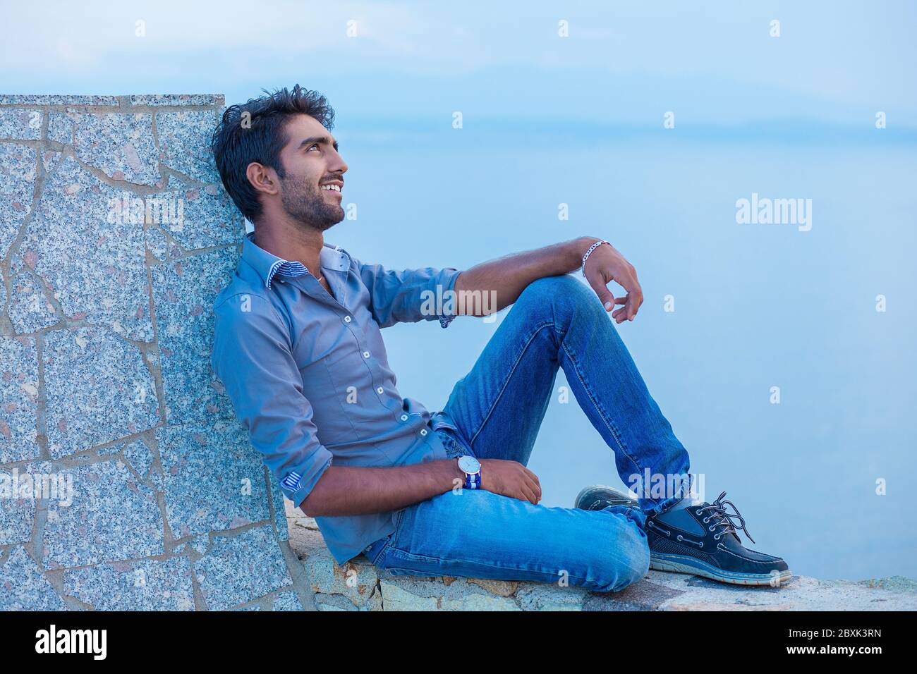 Man smiling looking up to blue sky taking deep breath celebrating ...