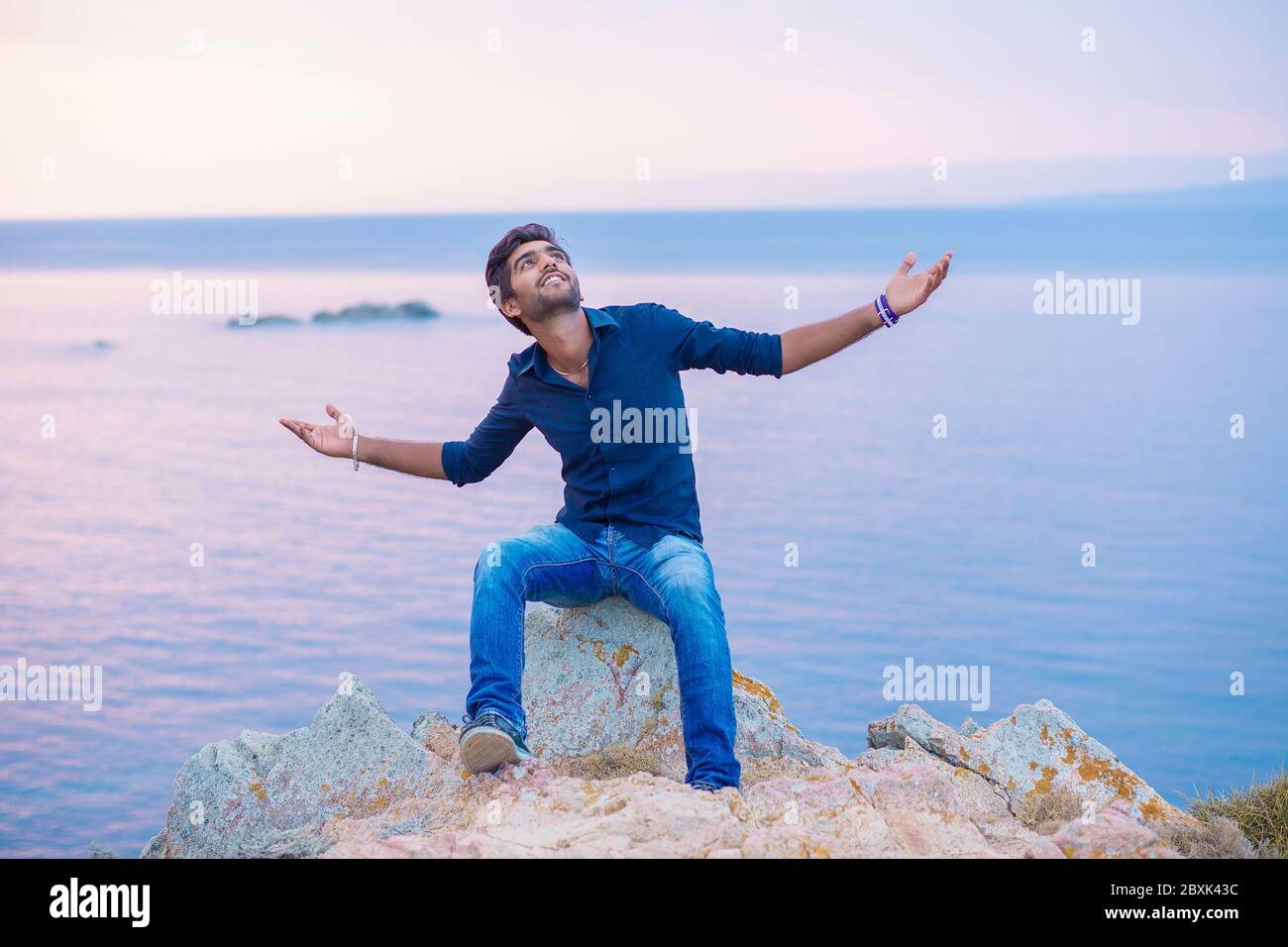 Man smiling looking up to blue sky taking deep breath celebrating ...