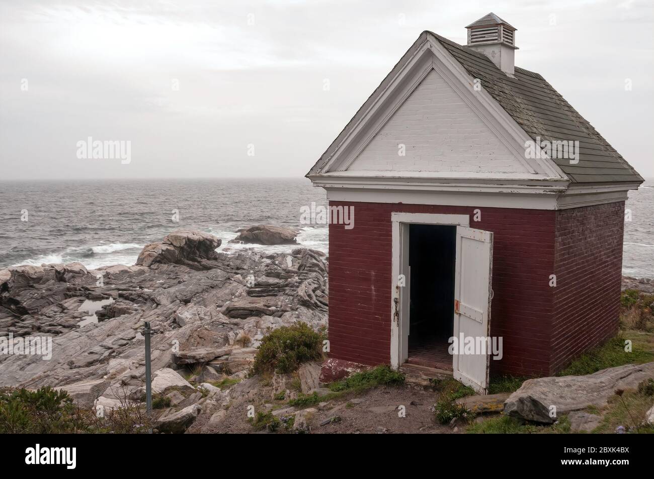 Oil shed, used for storing lighthouse oil, sitting on the rocks with ...