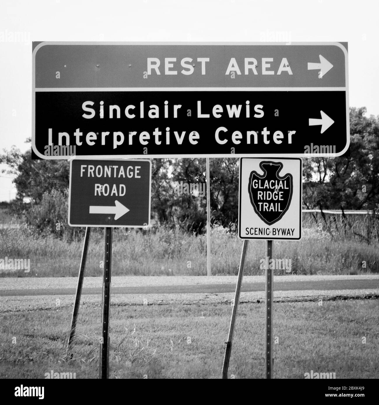 A collection of road signs for a Rest area, a frontage road, the ...