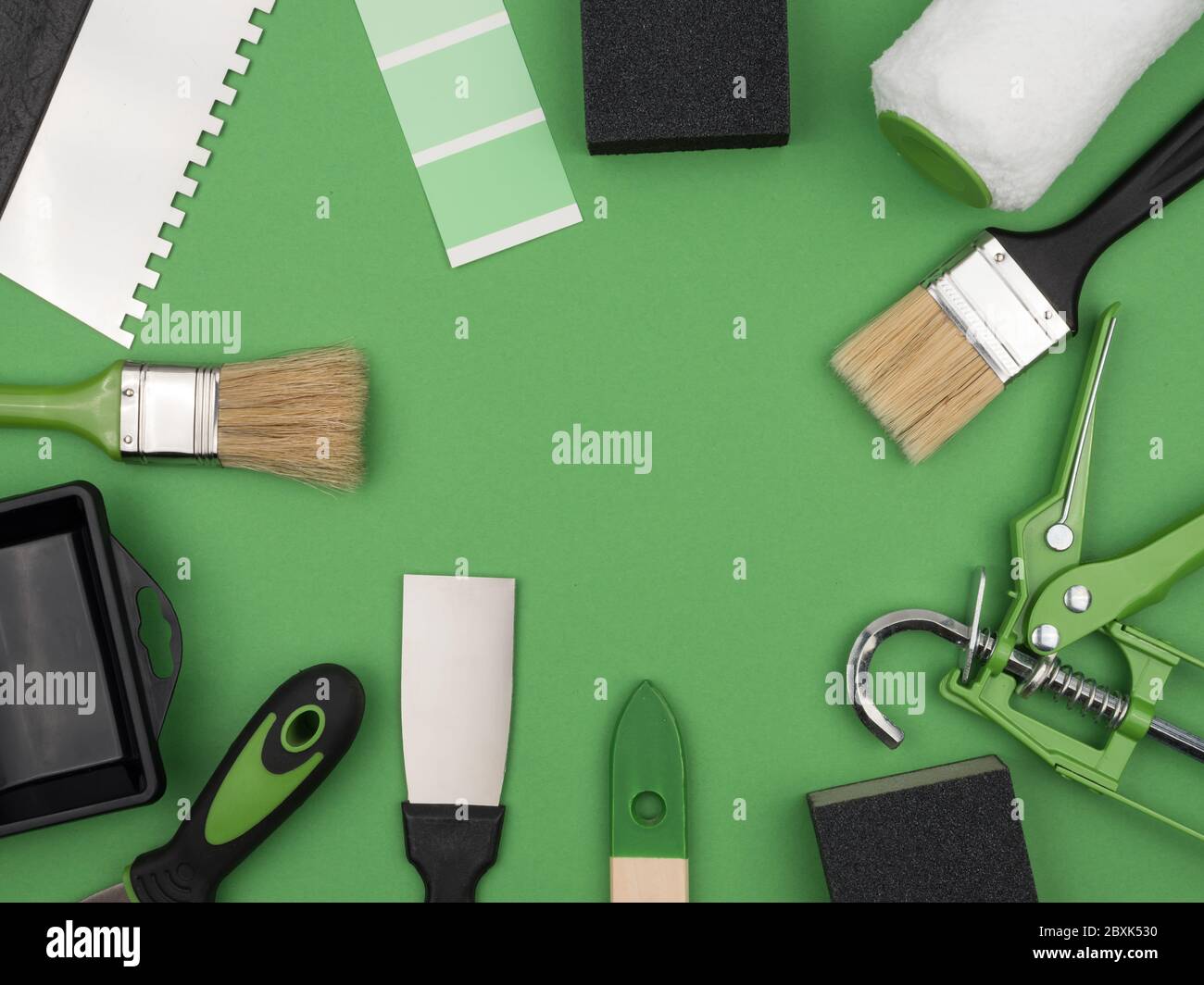 Tool painter plasterer on a green background Stock Photo - Alamy