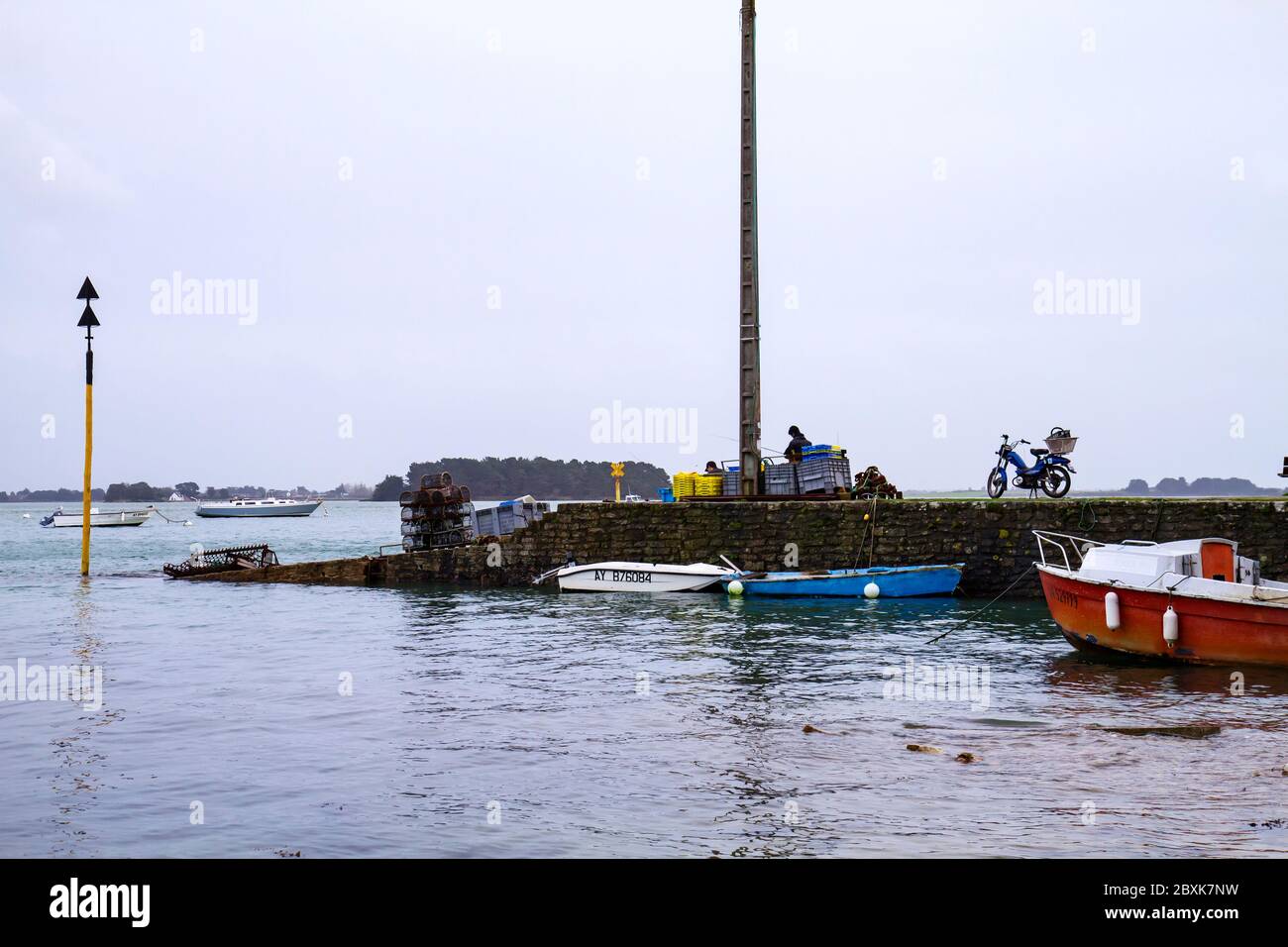 Small boats and fishermens on the dike Stock Photo - Alamy