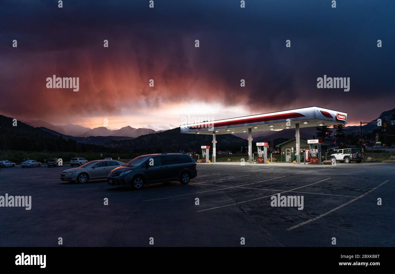 Sunset against storm clouds seen at a gas station Stock Photo - Alamy