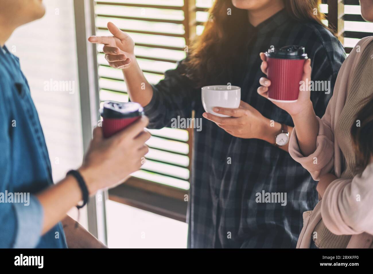 People enjoyed talking and drinking coffee together in office Stock ...
