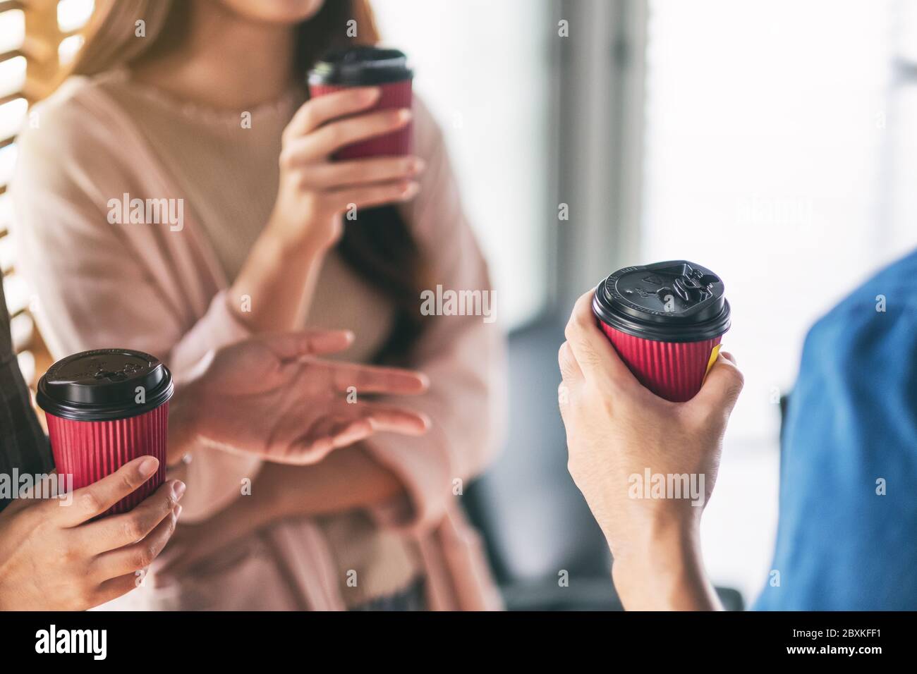 People enjoyed talking and drinking coffee together in office Stock ...