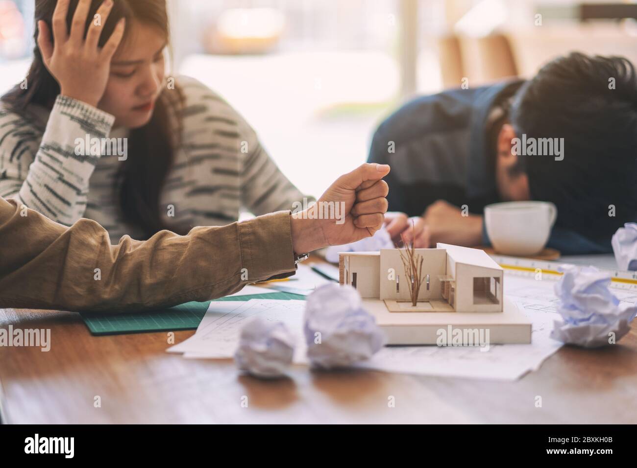 Closeup image of an angry and stressed architects try to destroy an ...