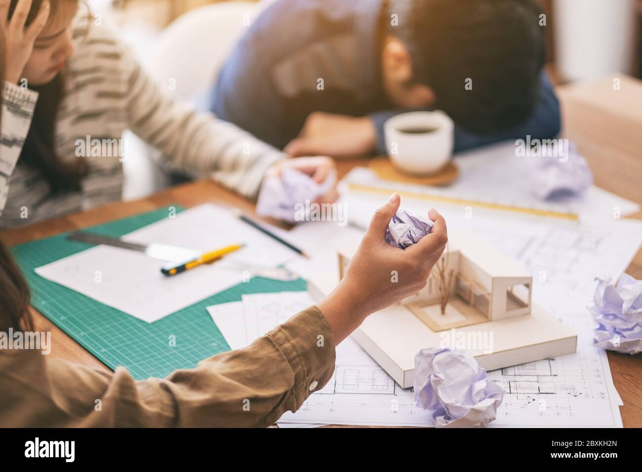 Group of an architect feel stressed after working on architecture model ...
