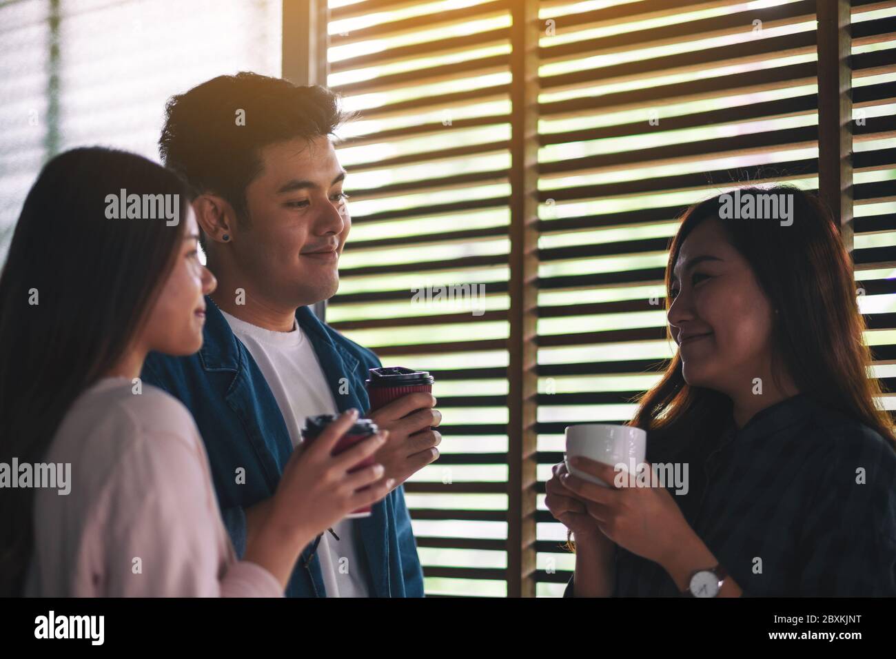 People enjoyed talking and drinking coffee together in office Stock ...