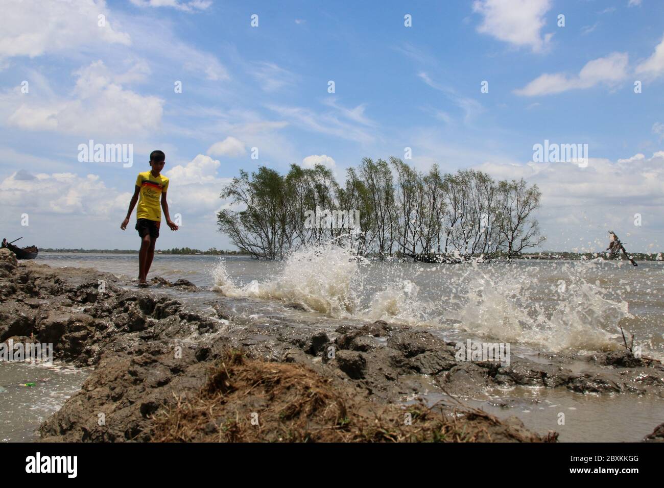 Assasuni, Bangladesh. 05th June, 2020. A boy walking through a muddy ...