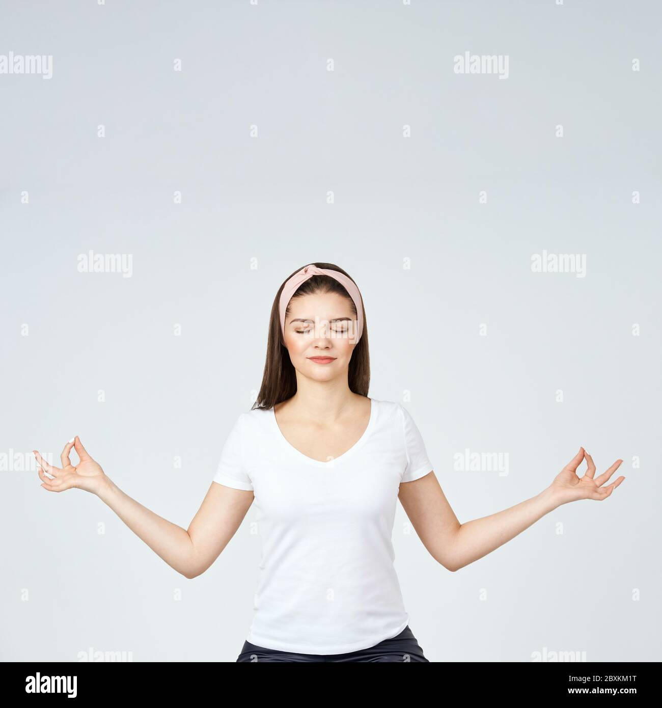 Young pretty girl in meditation position. Calm zen thinker. Hands ...