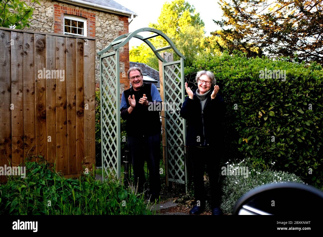 Clap for the NHS couple outside their house on the roadside smiling and ...