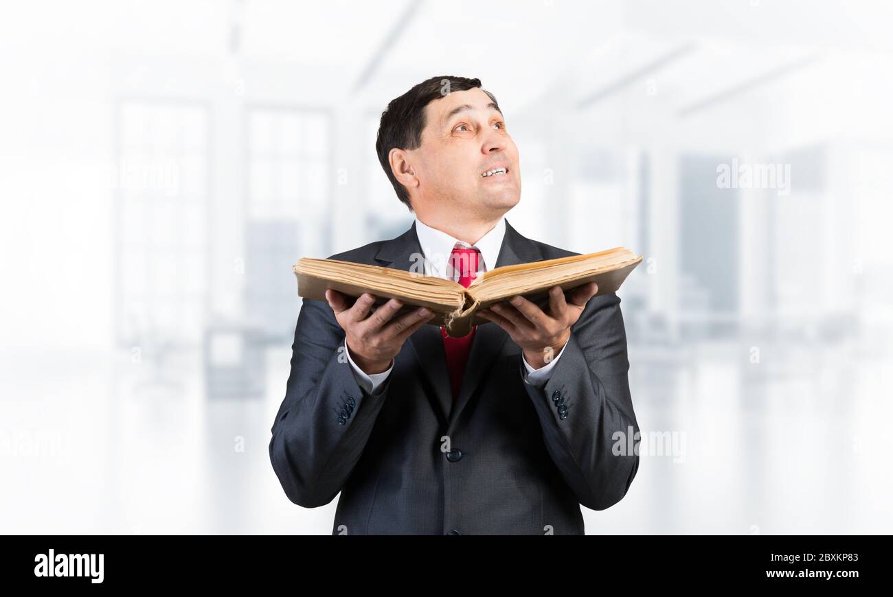 Happy senior businessman holding open book Stock Photo - Alamy