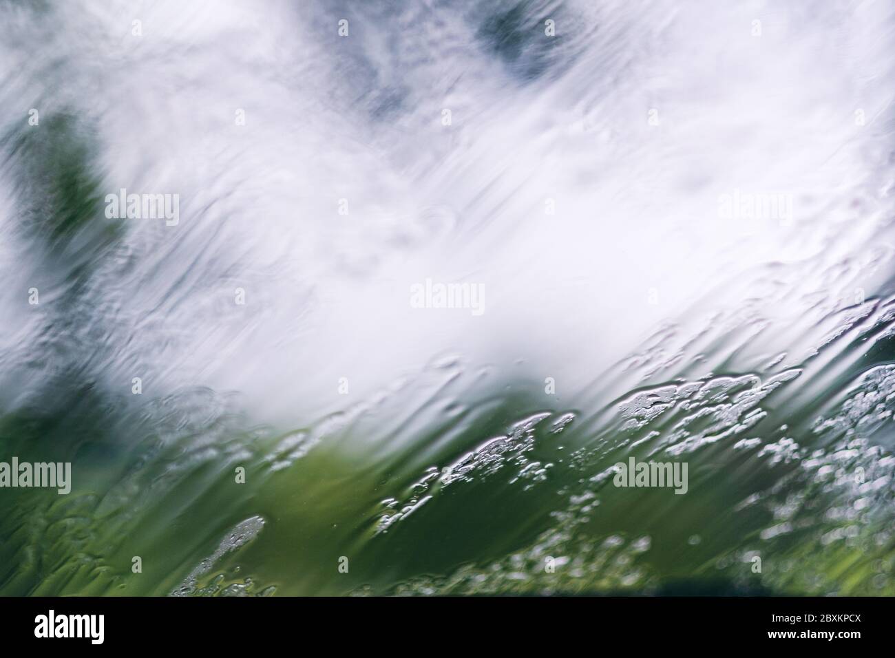 Rain falling outside the window with green nature background Stock ...