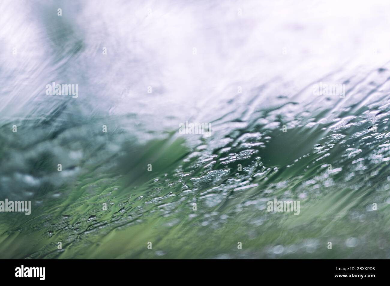 Rain falling outside the window with green nature background Stock ...