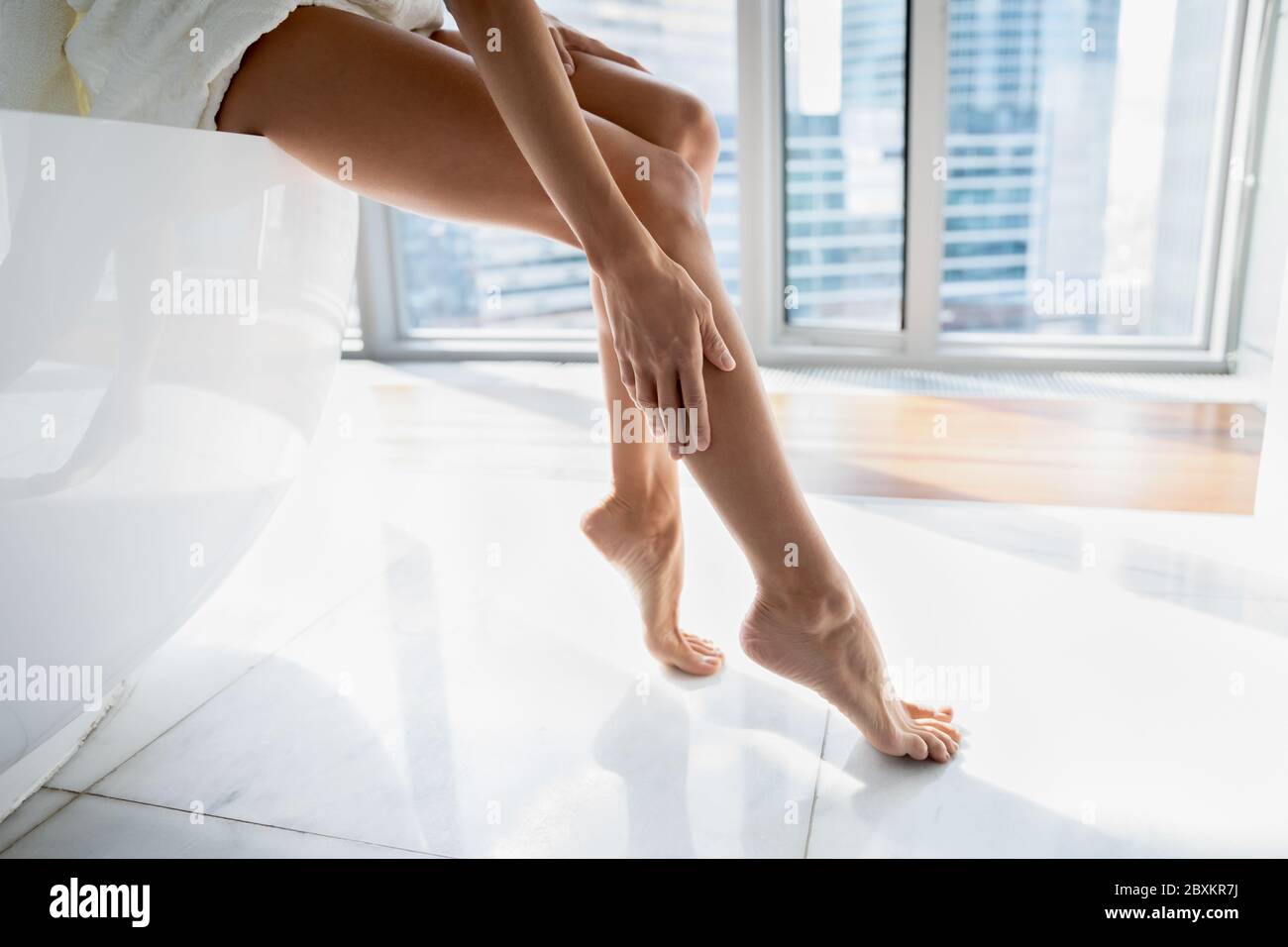 Legs woman young beautiful touching hi-res stock photography and images ...