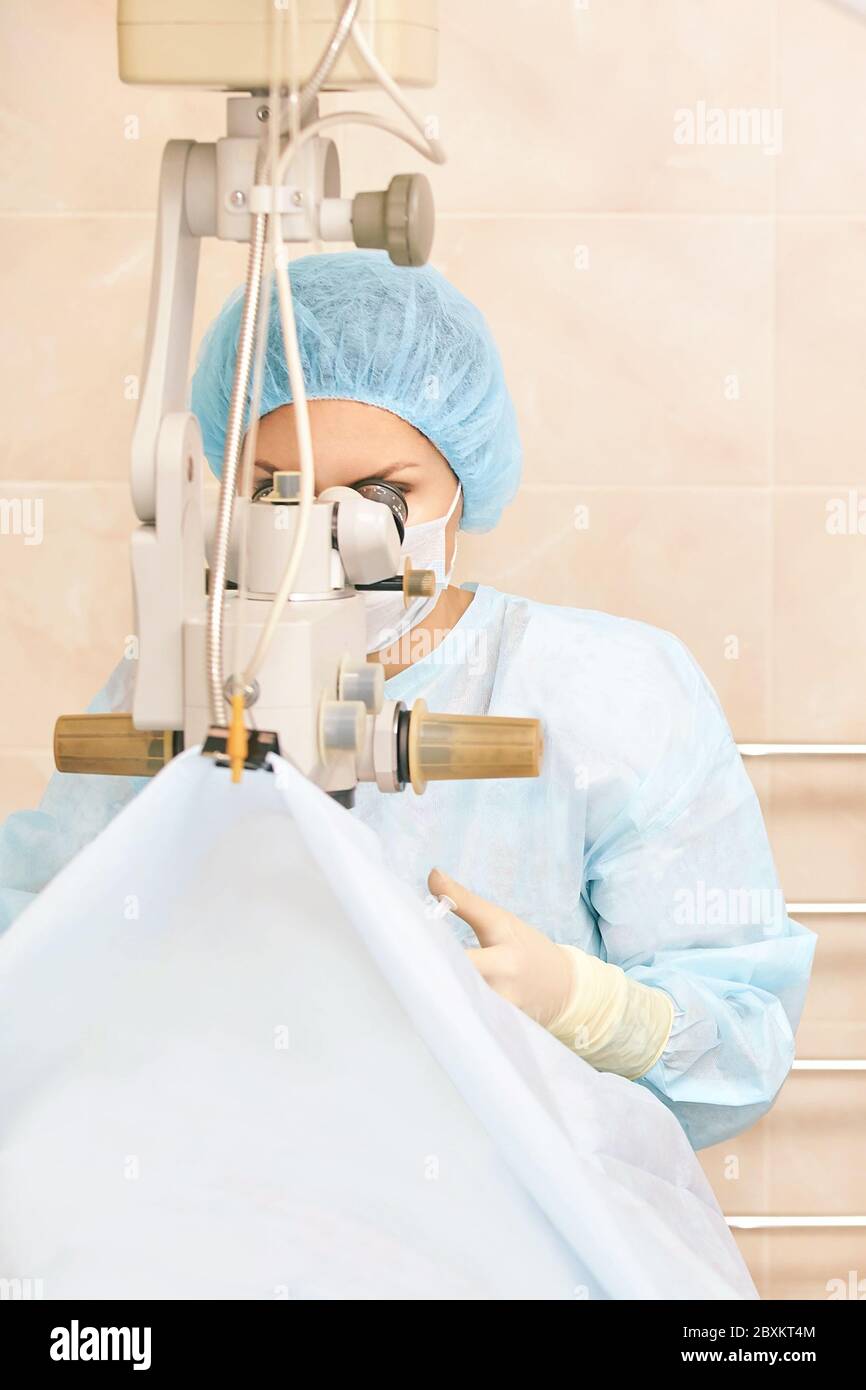 Ophthalmology laser microscope operation. Doctor in clinic. Patient eye ...