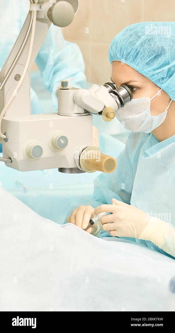 Ophthalmology laser microscope operation. Doctor in clinic. Patient eye ...