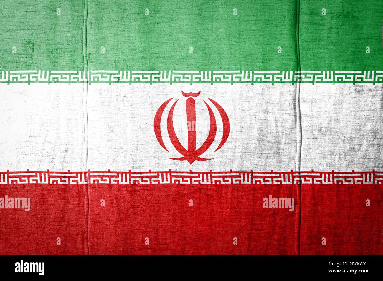 National flag of Iran depicting in paint colors on old textile. Flag ...