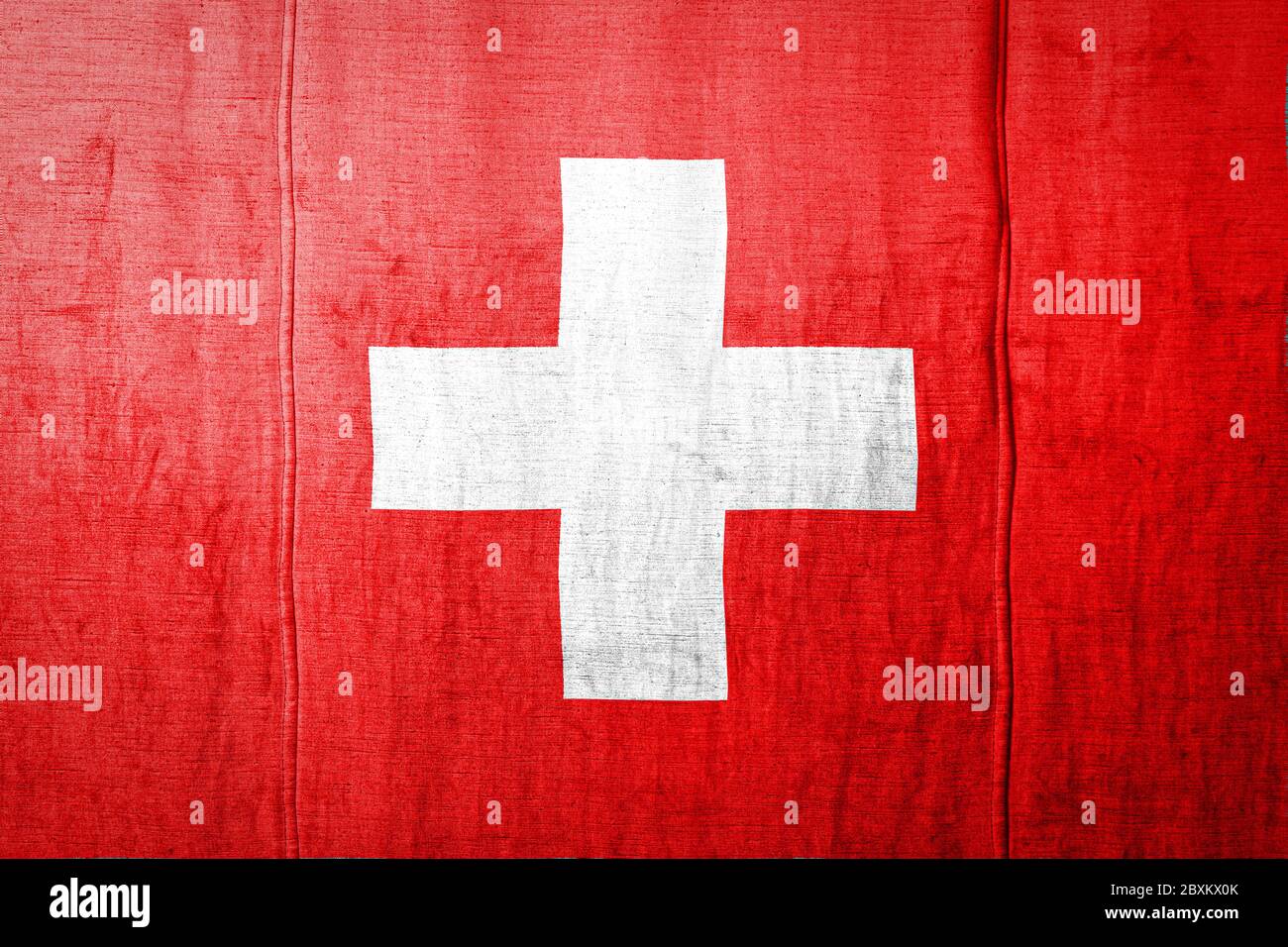 National flag of Switzerland depicting in paint colors on old textile ...